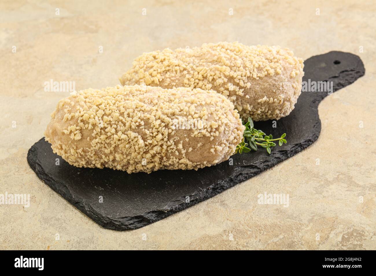 Raw breaded chicken cutlet for roast Stock Photo - Alamy