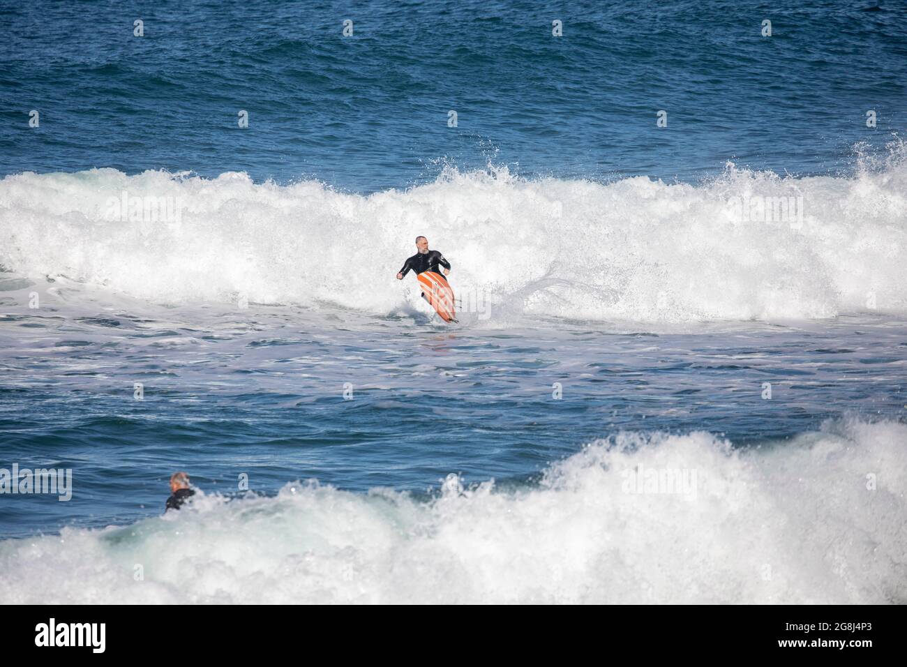 Man riding surf into beach hi-res stock photography and images - Alamy