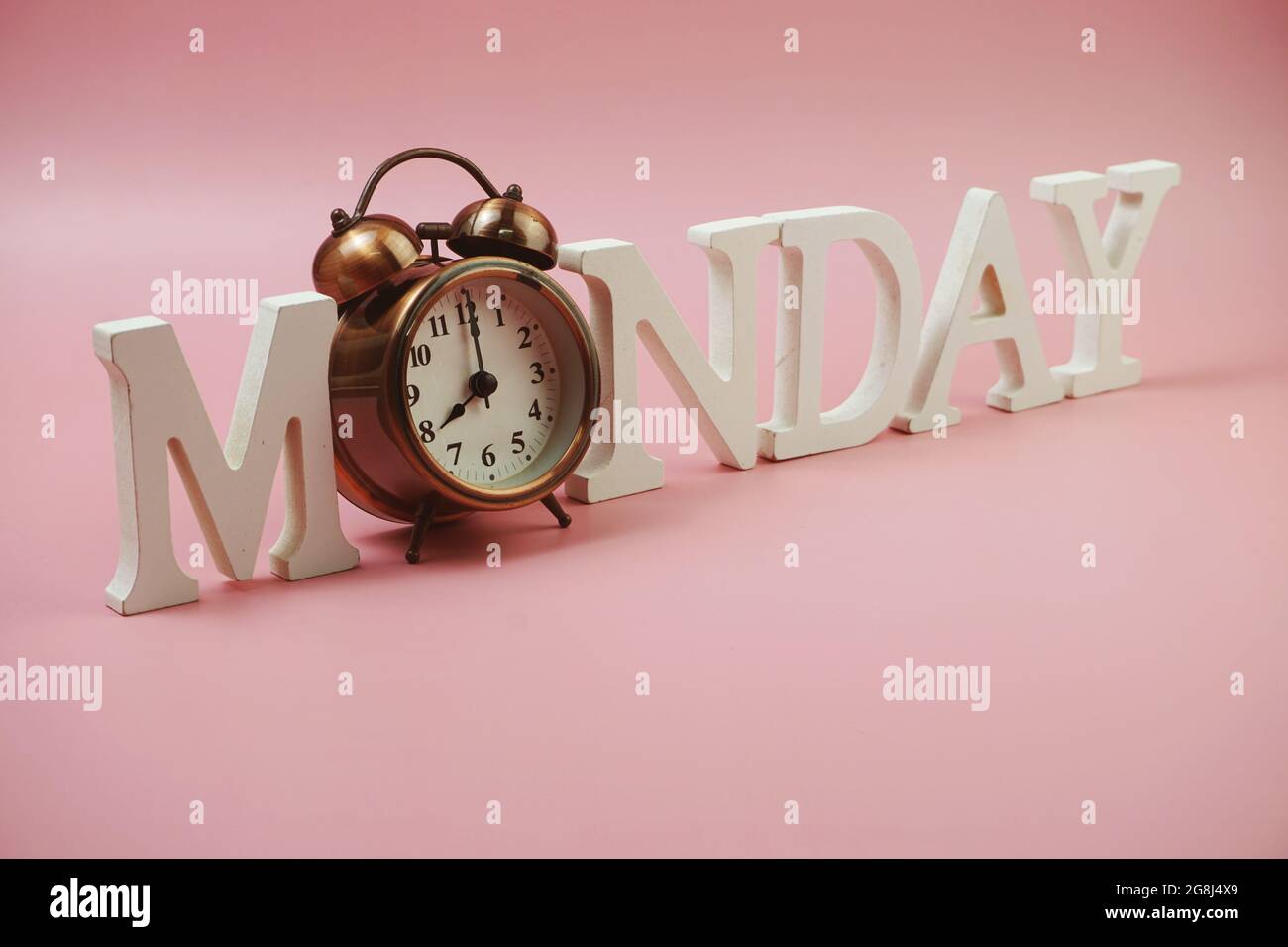 Monday alphabet letters with alarm clock on red background Stock Photo ...