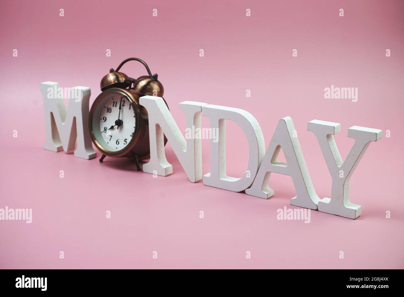 Monday alphabet letters with alarm clock on red background Stock Photo ...