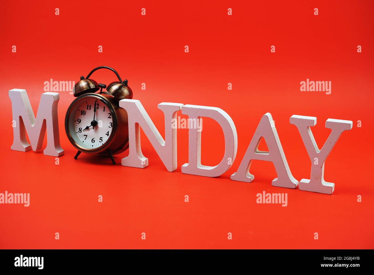 Monday alphabet letters with alarm clock on red background Stock Photo ...