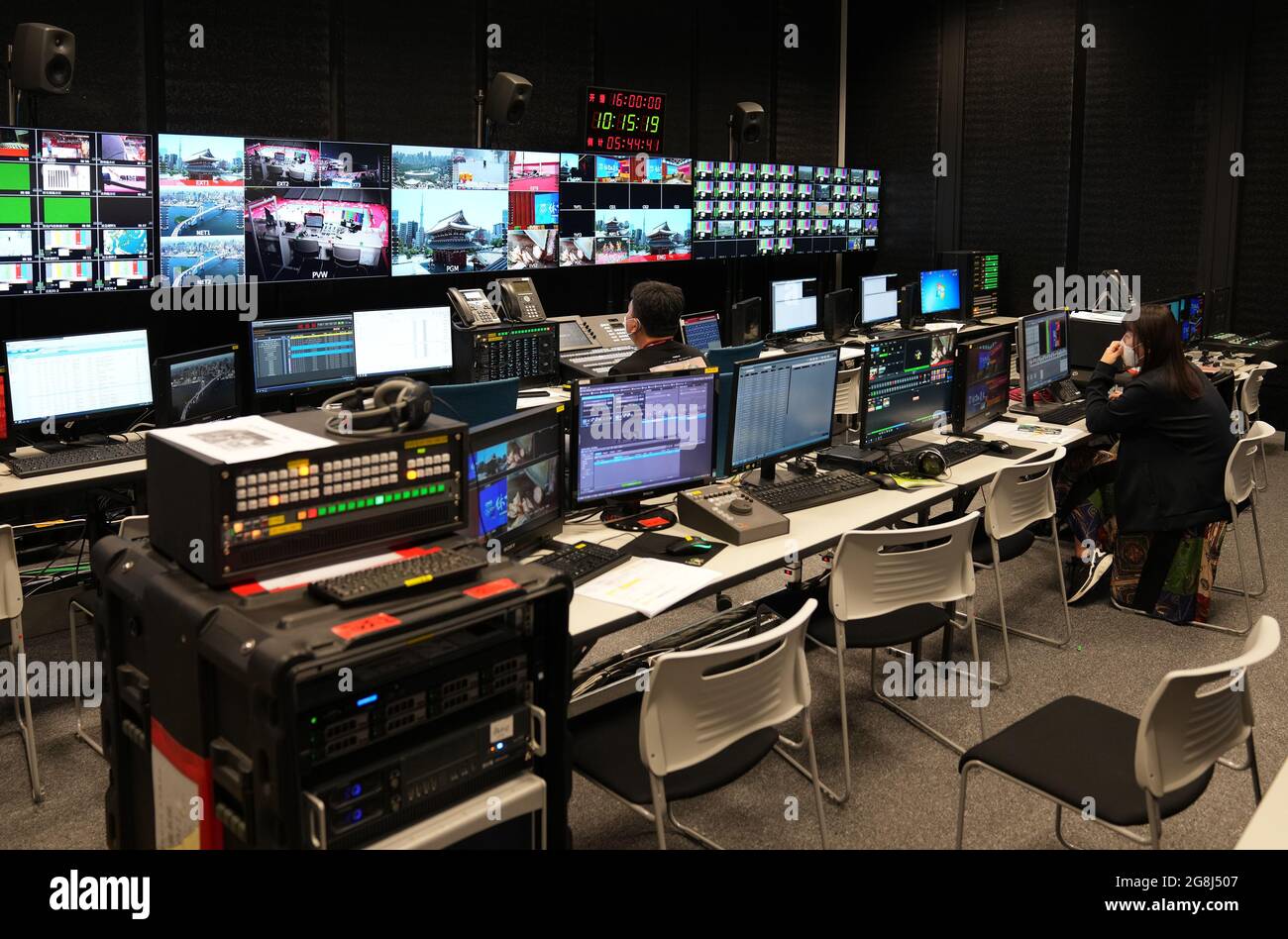 Tokyo, Japan. 21st July, 2021. Staff members of a broadcaster work in ...