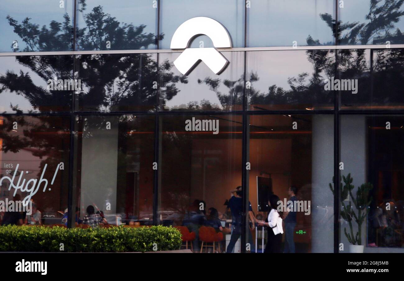 People walk past a NIO flagship store in Shanghai, China, 17 July 2021 ...