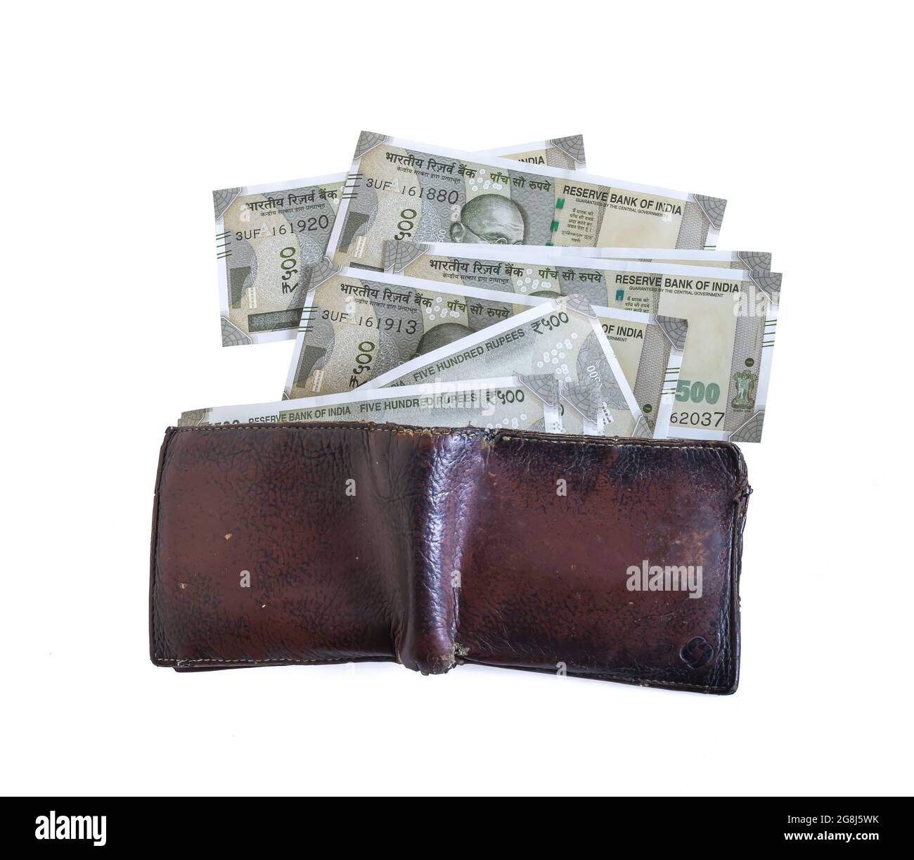 Wallet with Indian rupees coming out of it on a plain white background ...