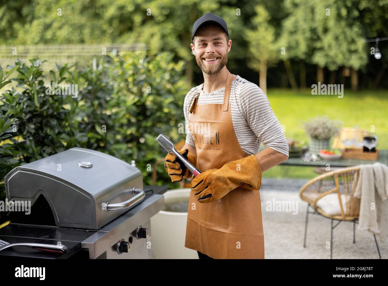 Handsome man preparing for cooking on grill Stock Photo - Alamy
