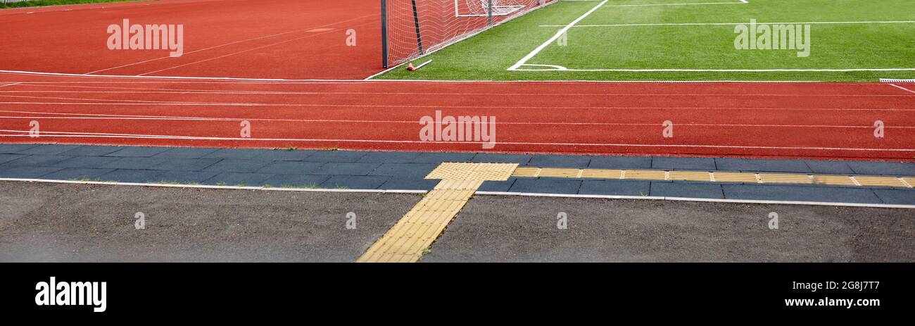 Red treadmill on sport field. Landscape of soccer field with green ...