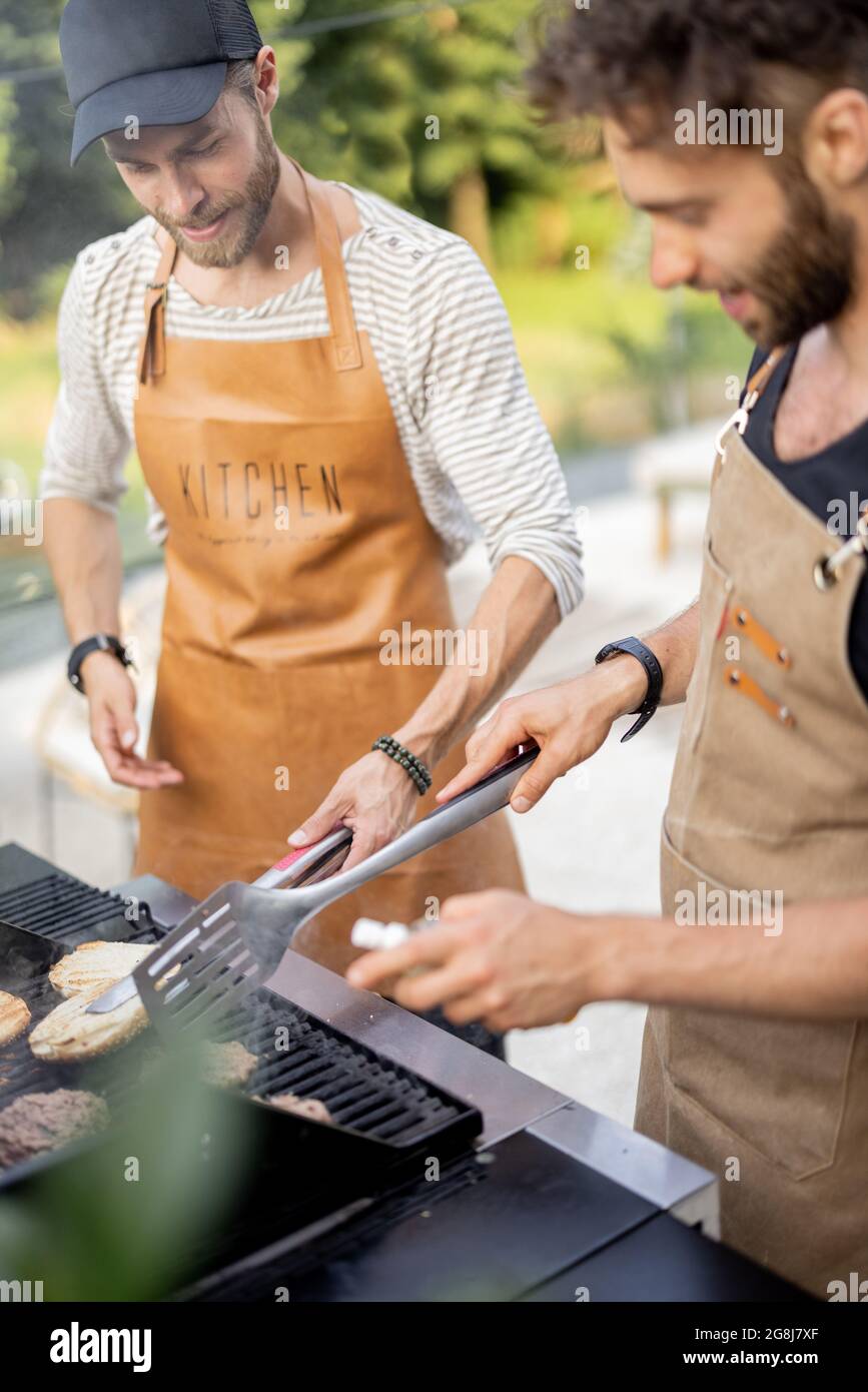 Two guys grilling at backyard Stock Photo - Alamy