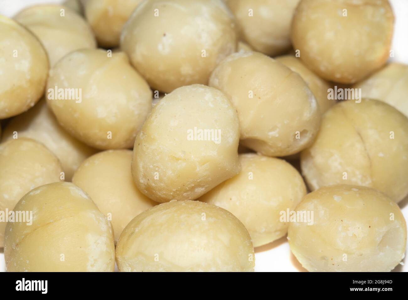 Peeled fresh macadamia nuts close up background Stock Photo - Alamy
