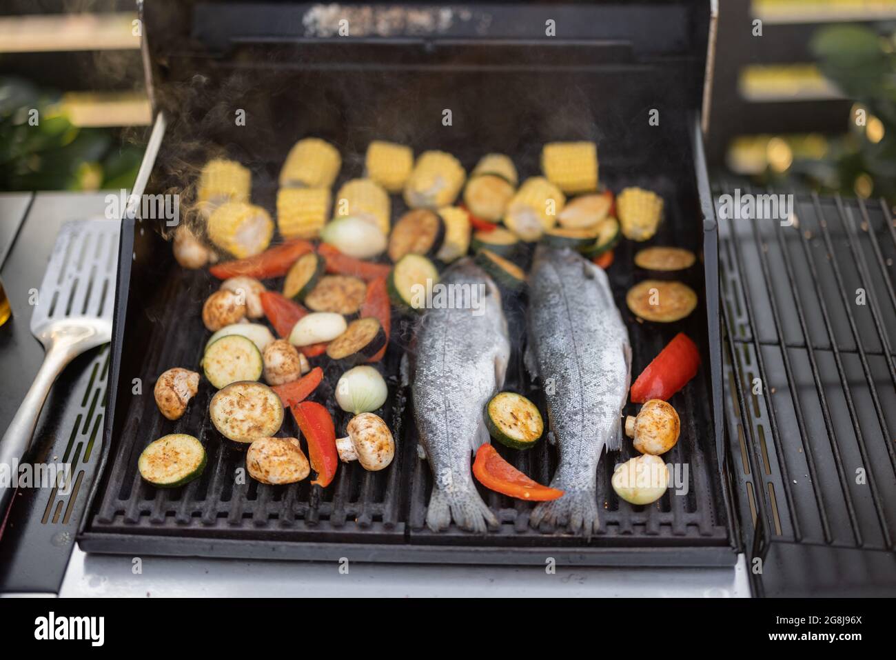Fish and vegetables on a grill Stock Photo - Alamy