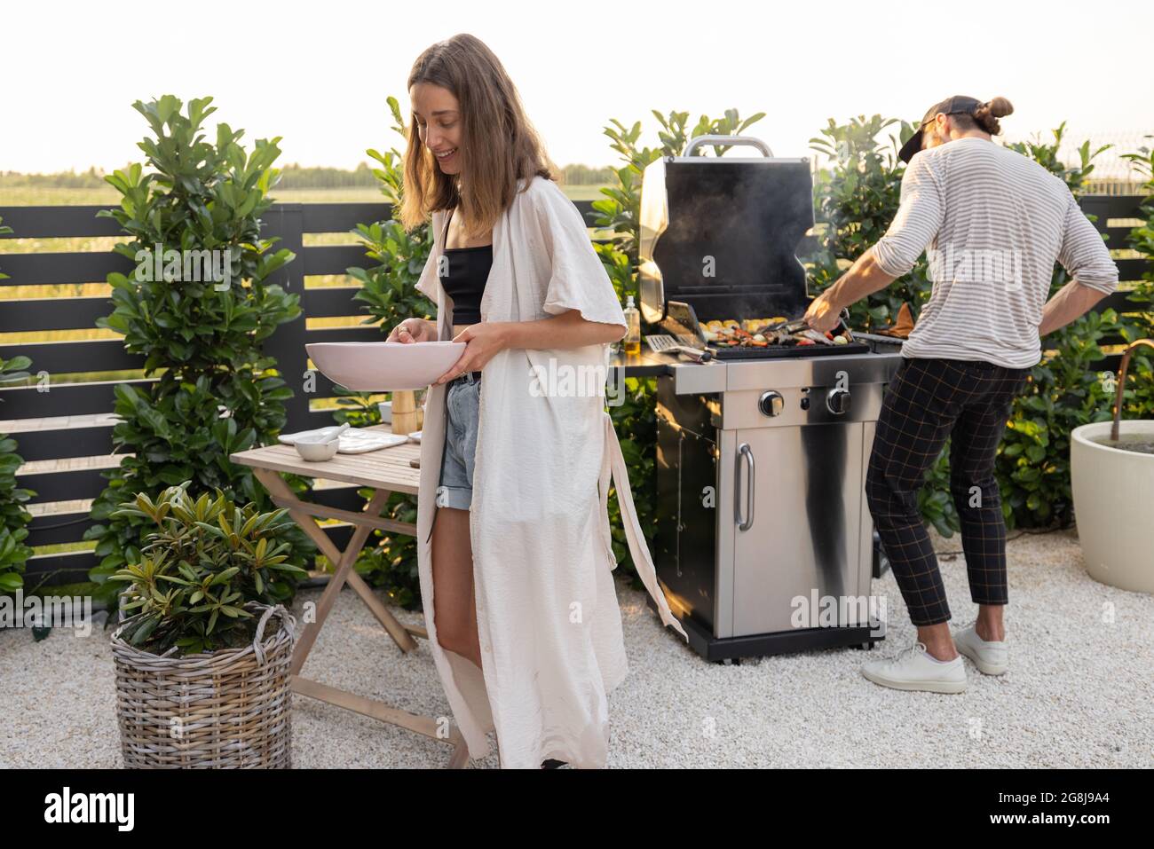 Man cooking on a grill outdoors Stock Photo - Alamy