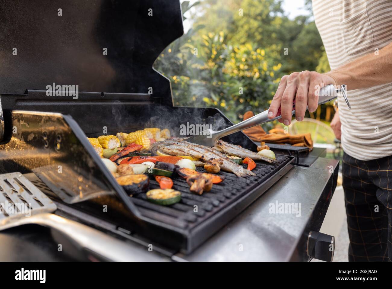 Grilling fish and corn on a grill Stock Photo - Alamy