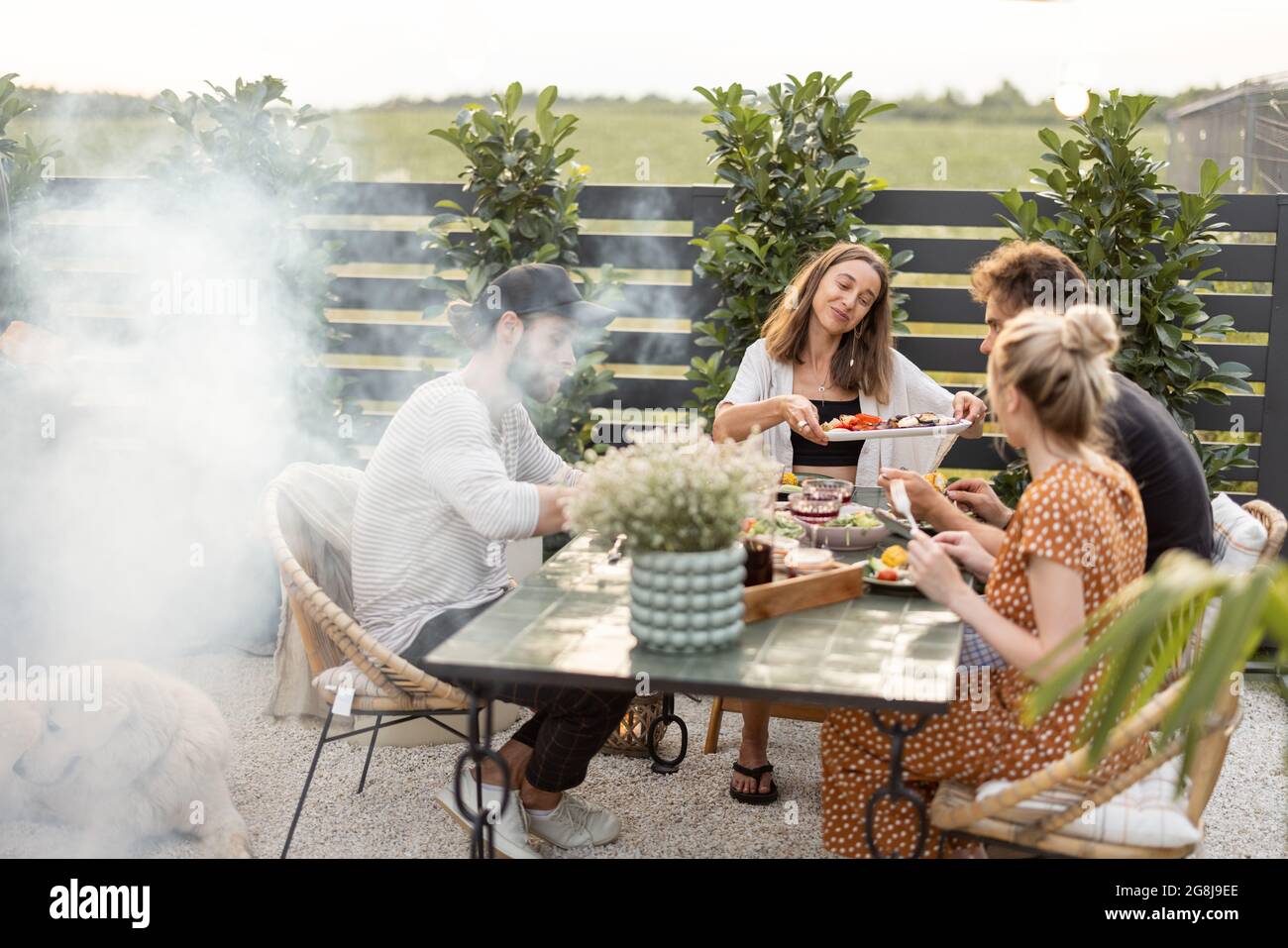 Friends eating lunch at backyard Stock Photo - Alamy