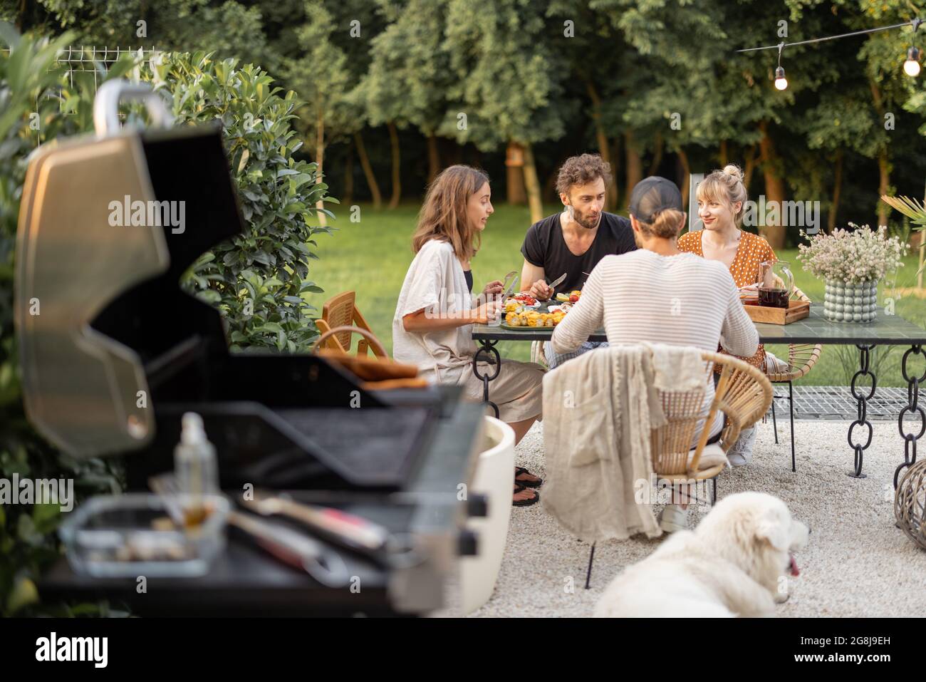 Friends eating lunch at backyard Stock Photo - Alamy