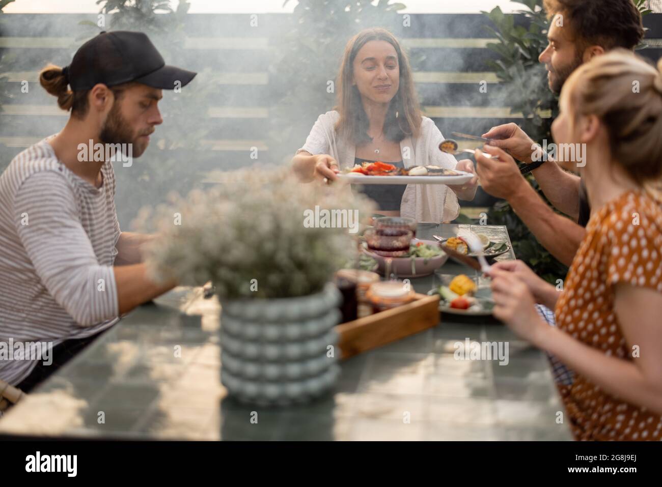 Friends eating lunch at backyard Stock Photo - Alamy