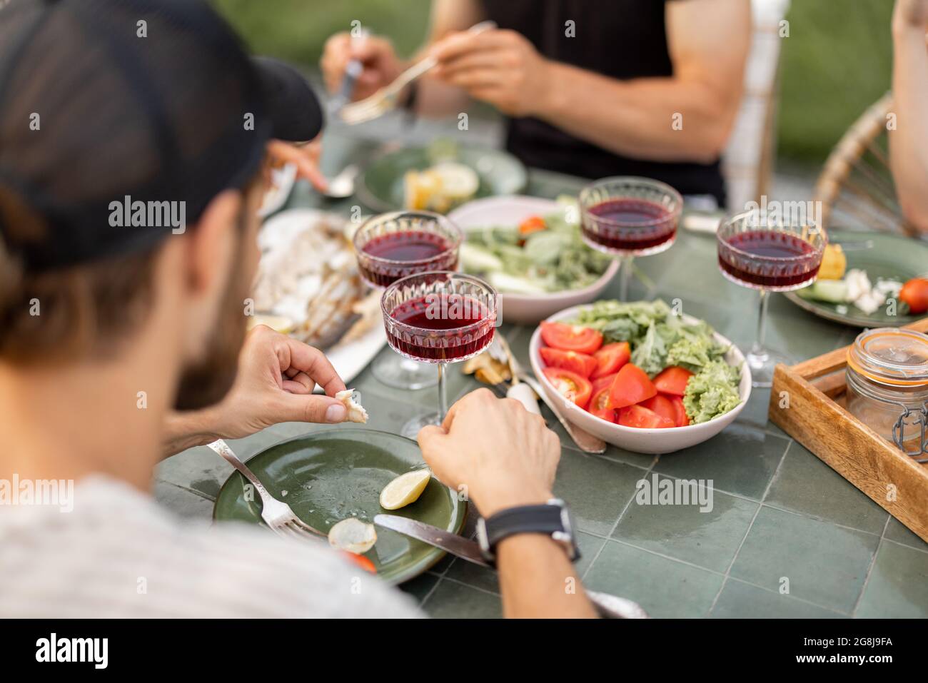 Friends eating lunch at backyard Stock Photo - Alamy