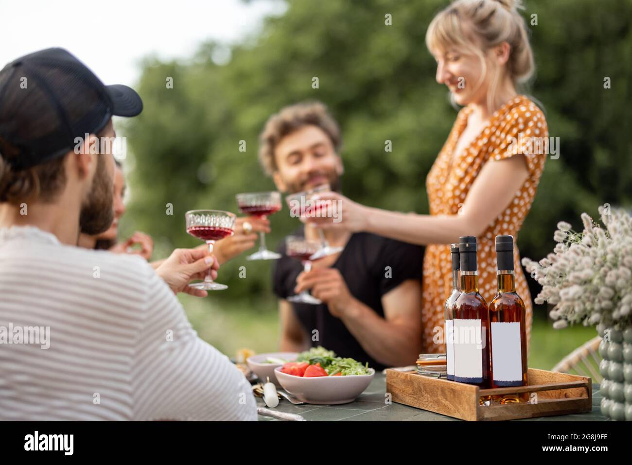 Friends drinking alcohol at festive dinner outdoors Stock Photo - Alamy