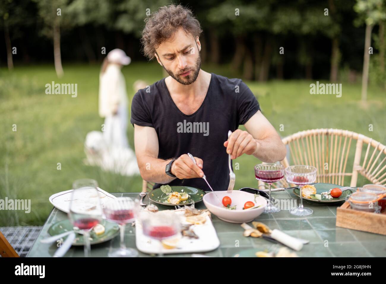 Guy eating at backyard outdoors Stock Photo - Alamy