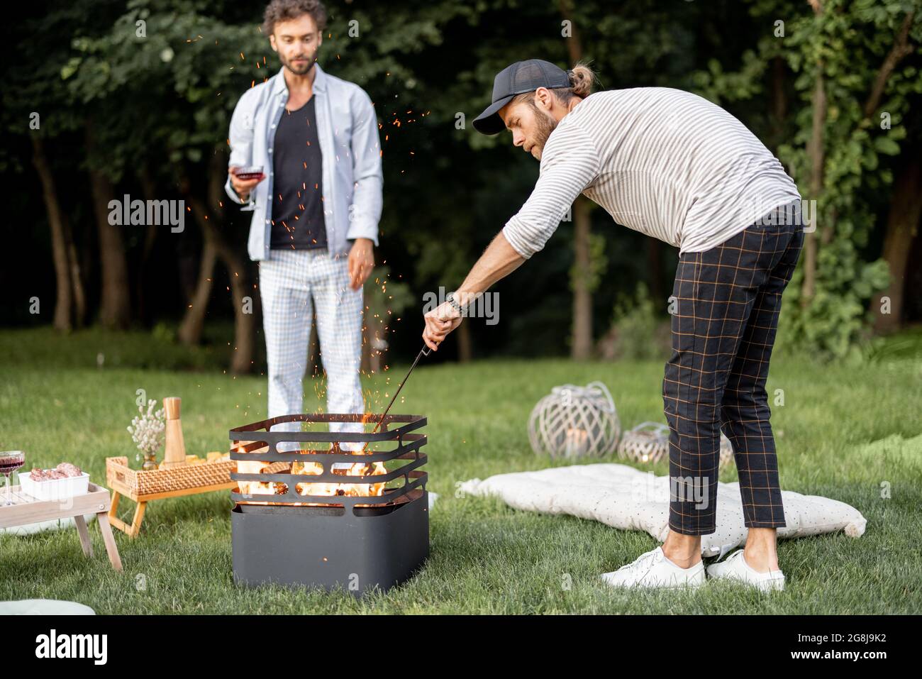 Guys on a picnic near the forest Stock Photo - Alamy