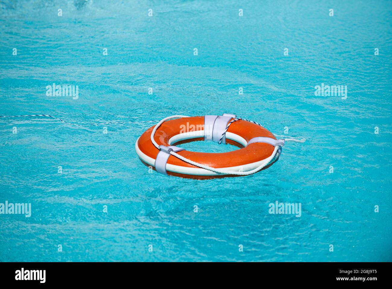 Lifebuoy in swimming pool. Summer vacation concept. Life buoy in water ...