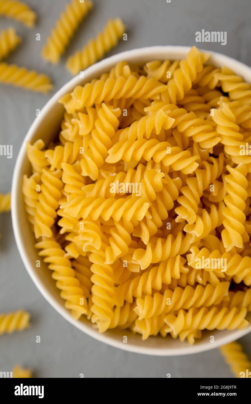 Uncooked Yellow Organic Rotini Pasta, top view. Flat lay, overhead ...