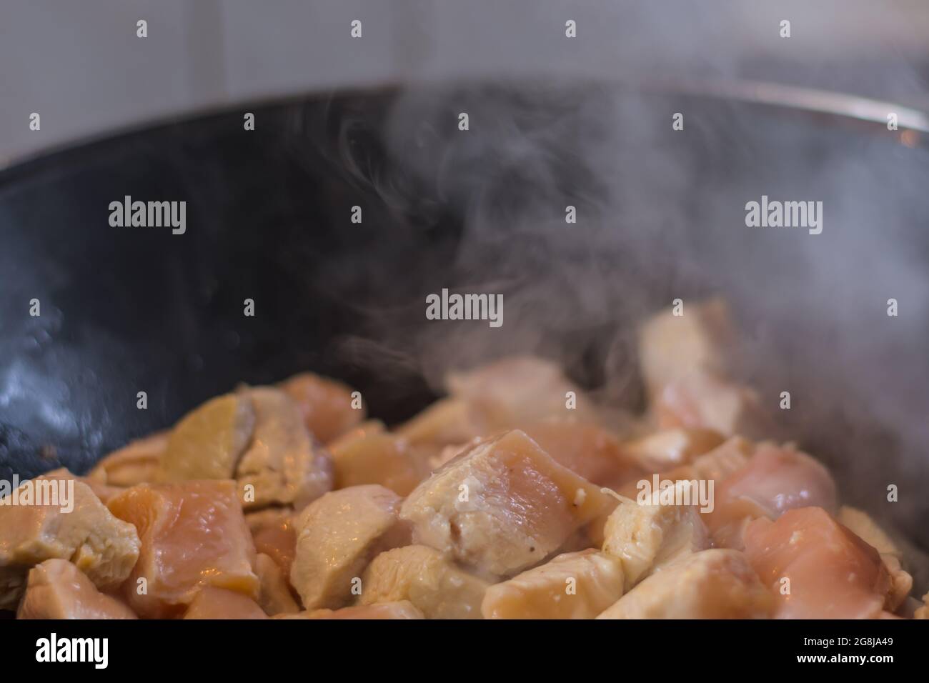 smoking cut meat while cooking Stock Photo - Alamy