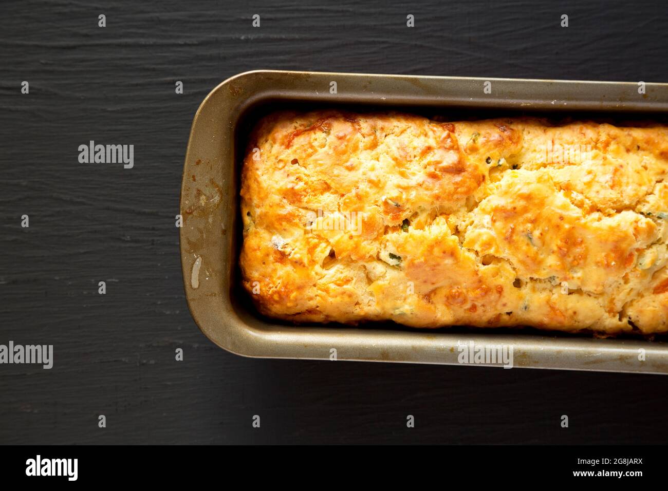 Homemade Cheesy Bread Loaf on a black surface, top view. Flat lay ...