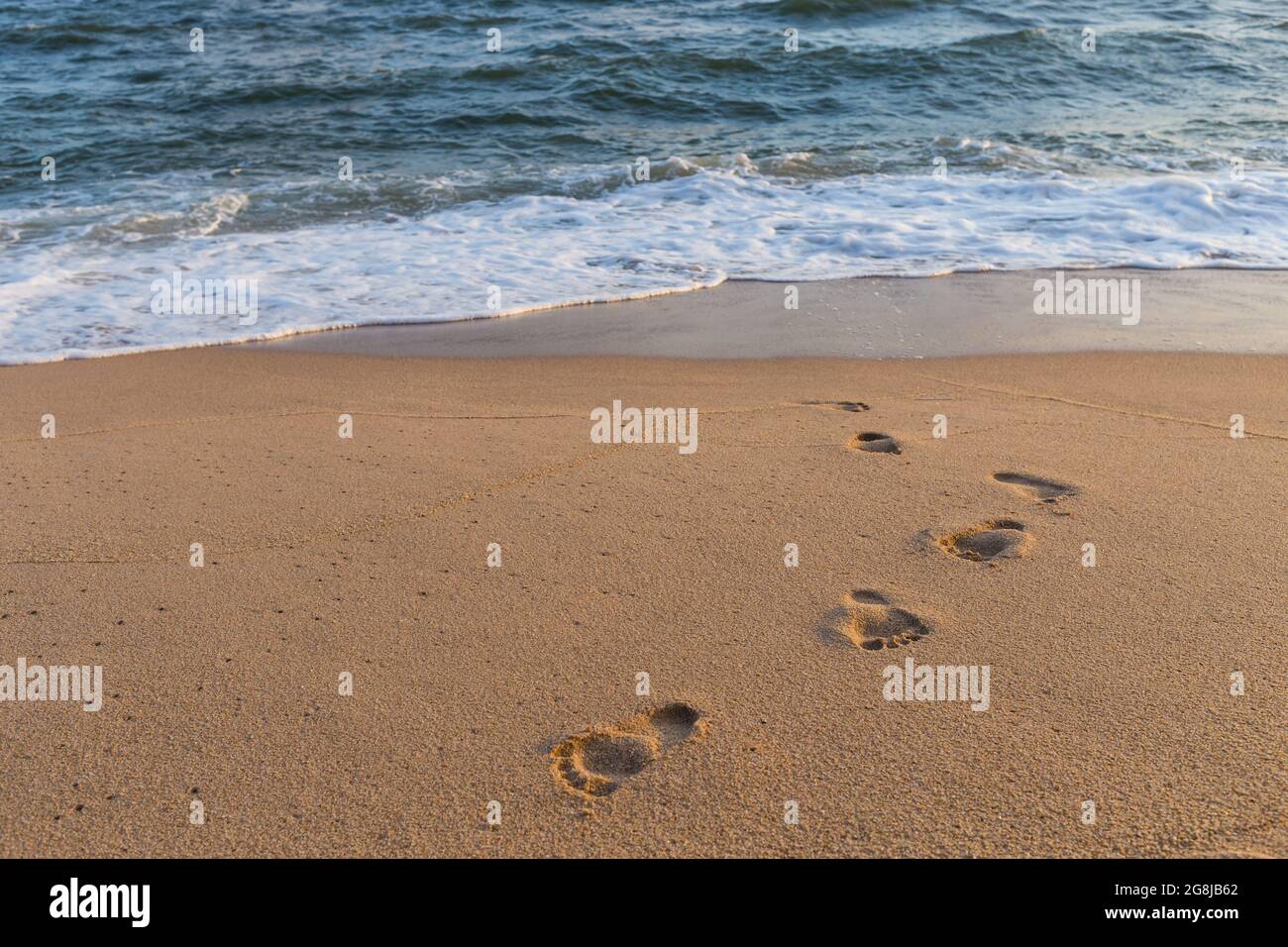 Footprints on the sand beach nature background Stock Photo - Alamy