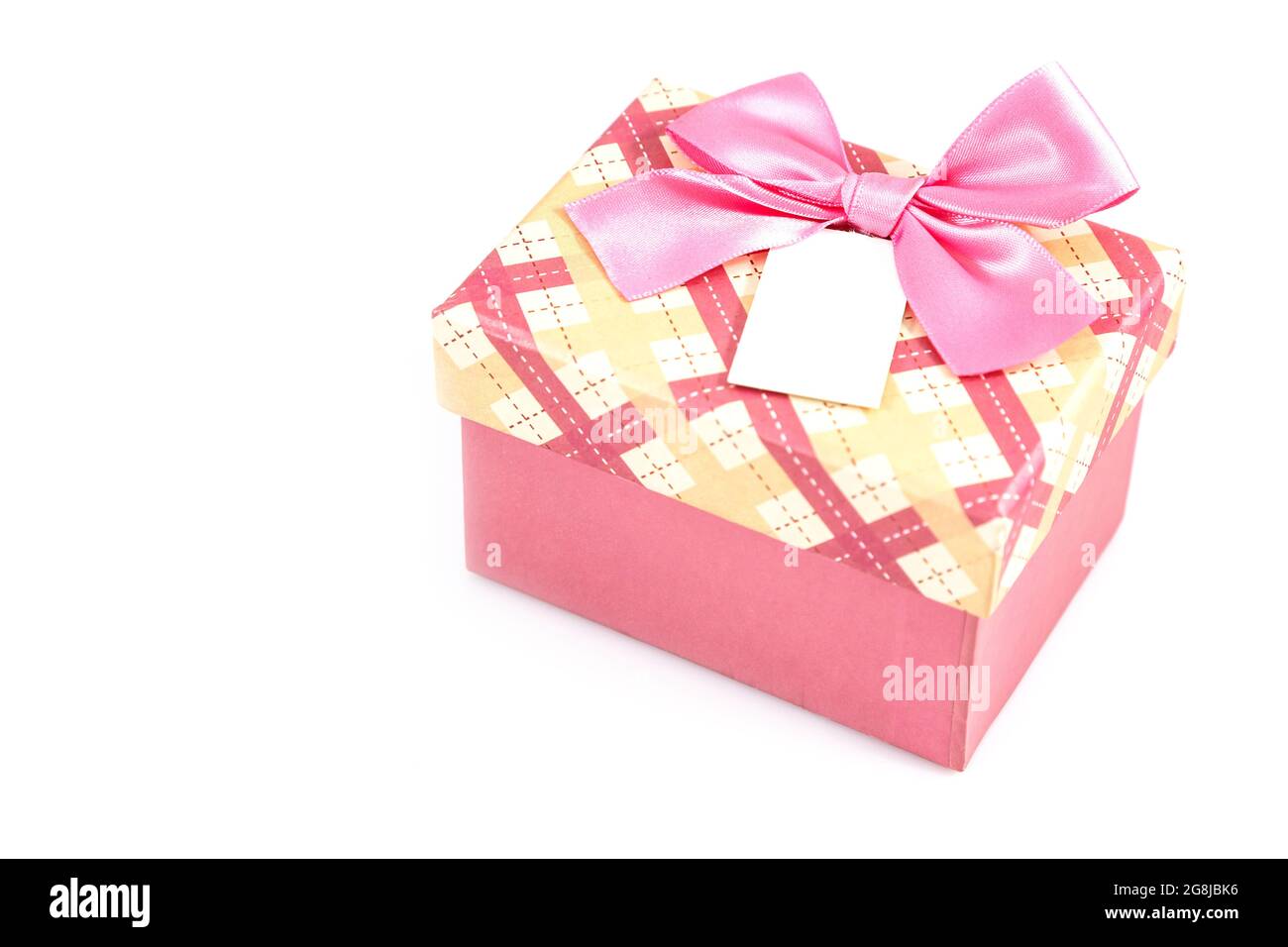 Pink Christmas gift box with pink bow and white tag isolated on white ...