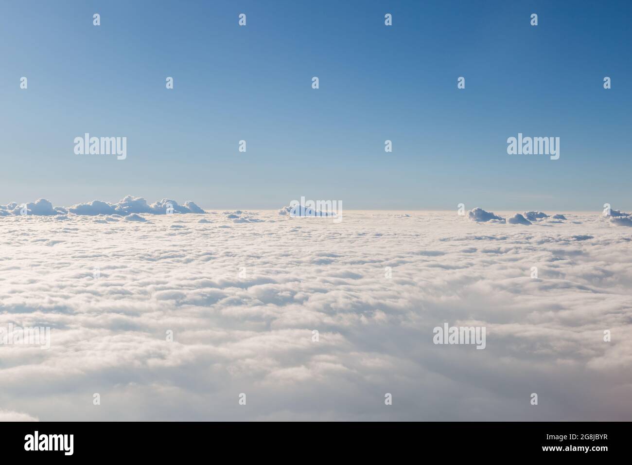 Fluffy white clouds and blue sky seen from airplane for background ...