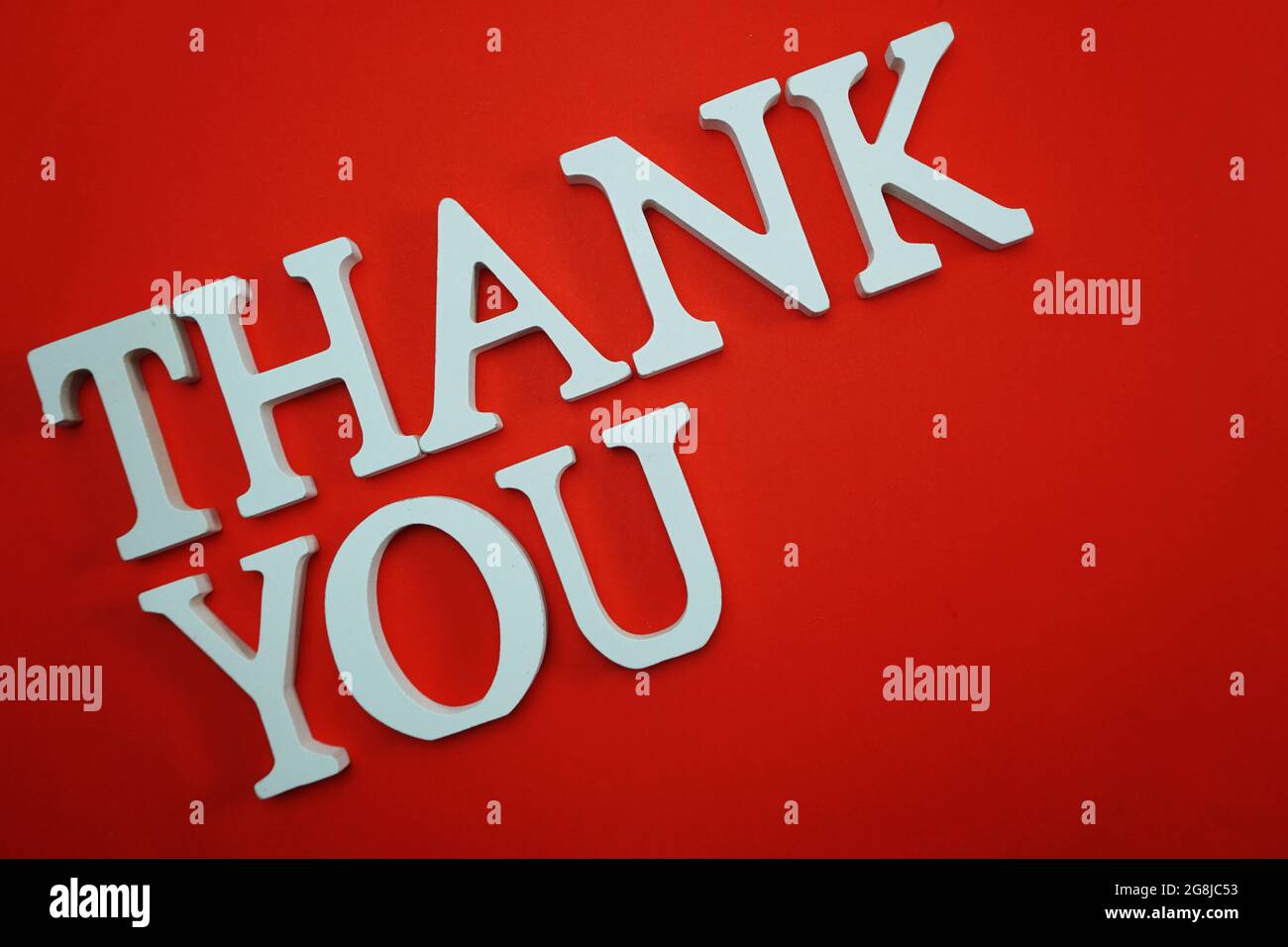 Thank You alphabet letters top view on red background Stock Photo - Alamy