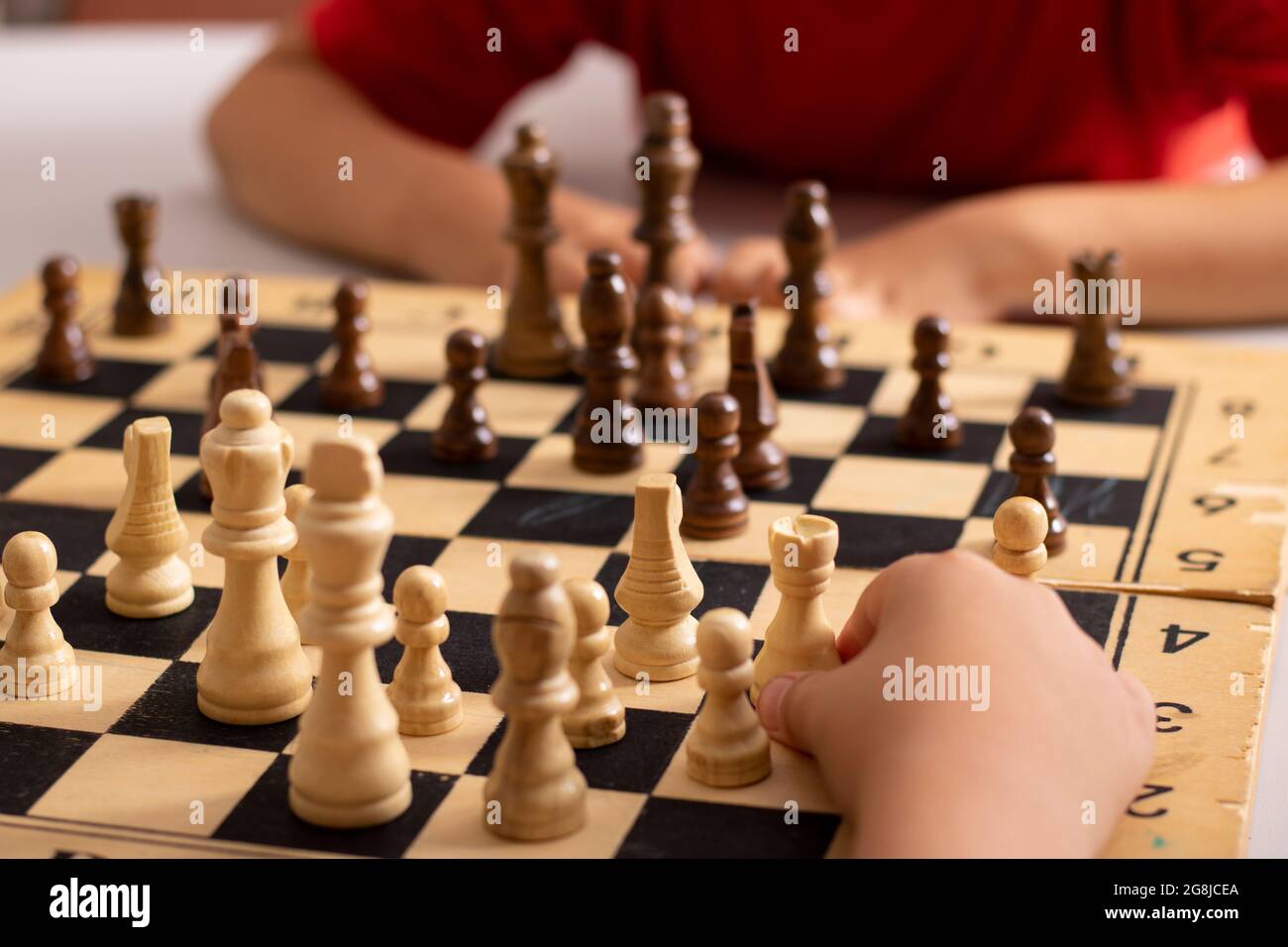 Kids hand holding rook to make a step, chess concept Stock Photo - Alamy