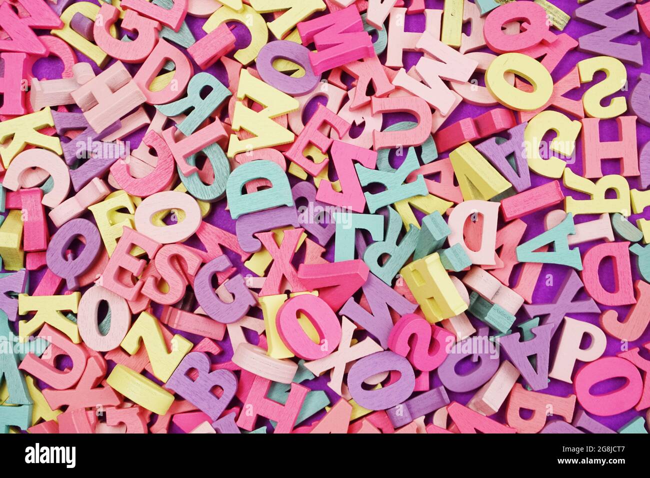 random colorful letterpress alphabet top view on yellow background ...