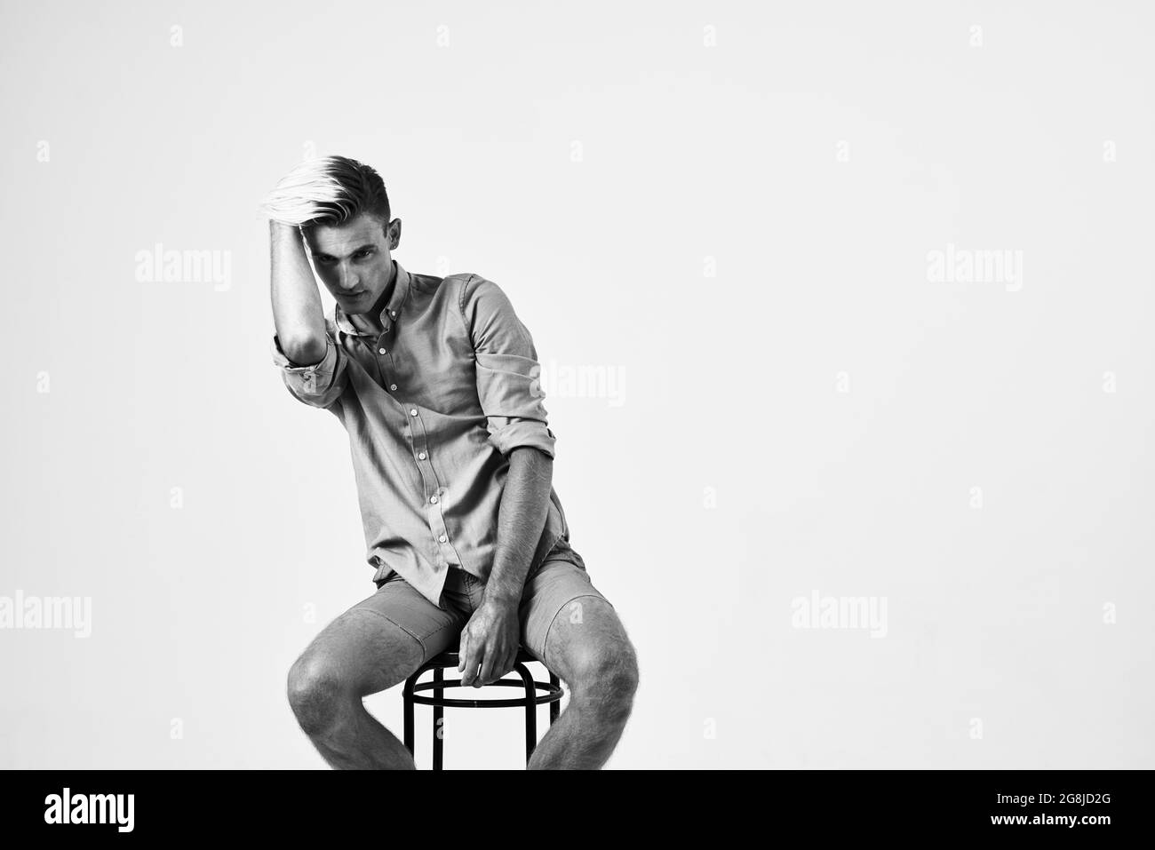 Handsome man sitting on chair Black and White Stock Photos & Images - Alamy
