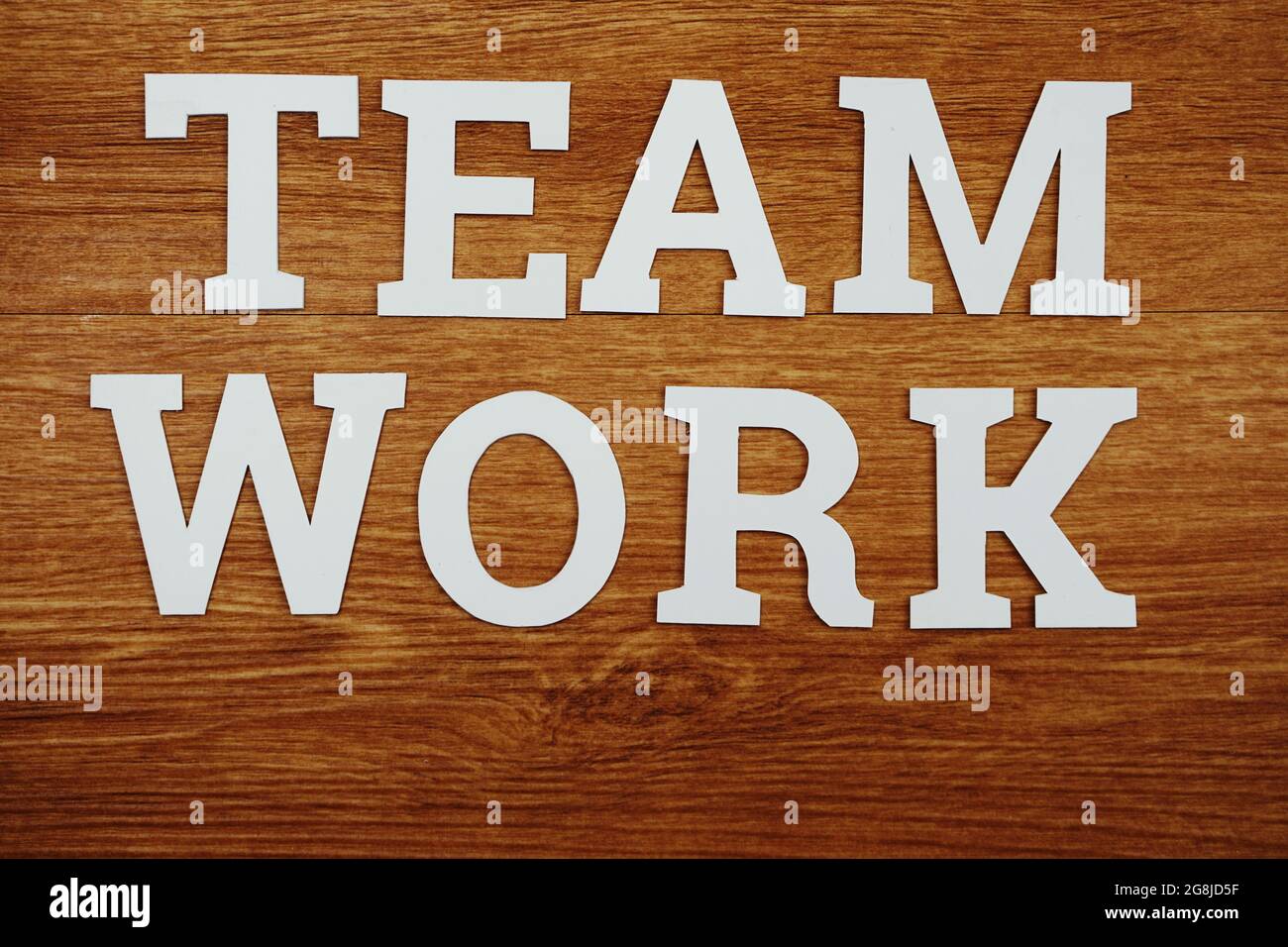 Teamwork alphabet letters on wooden background Stock Photo - Alamy