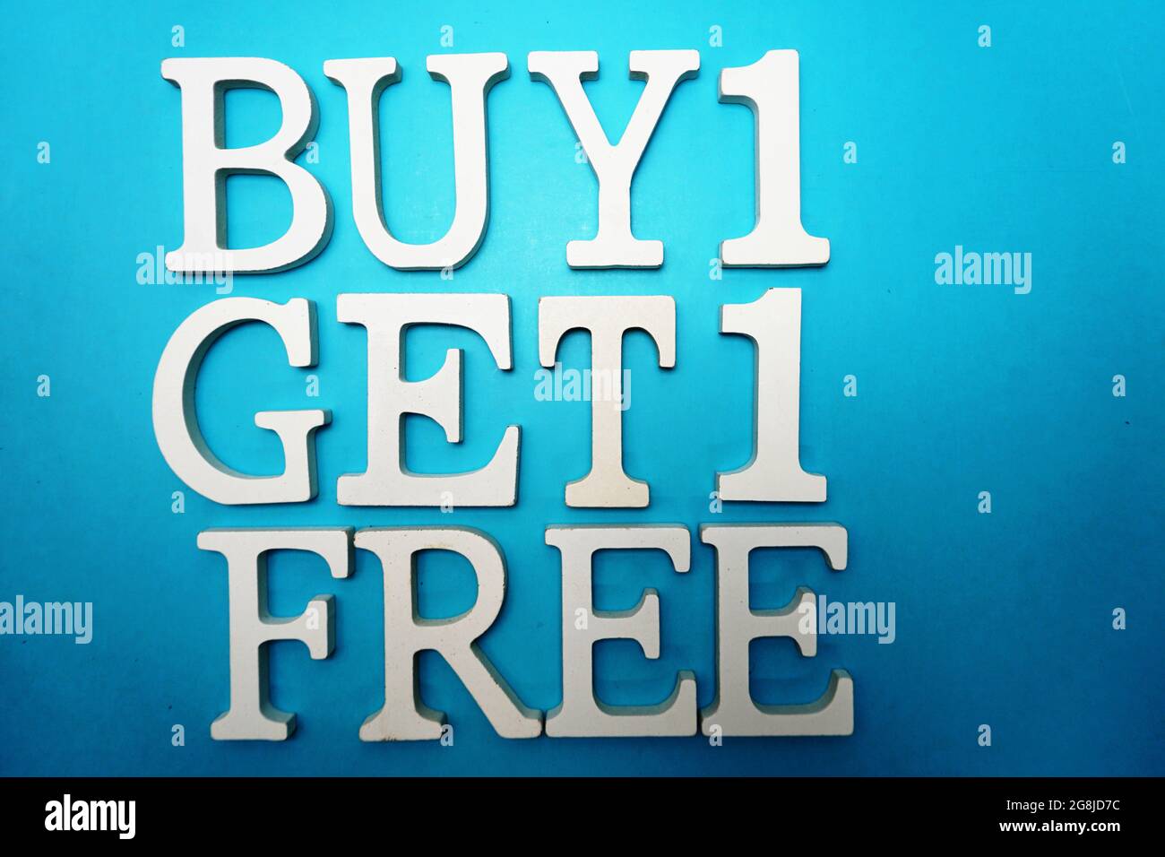 BUY 1 GET 1 FREE alphabet letters on blue background Stock Photo - Alamy