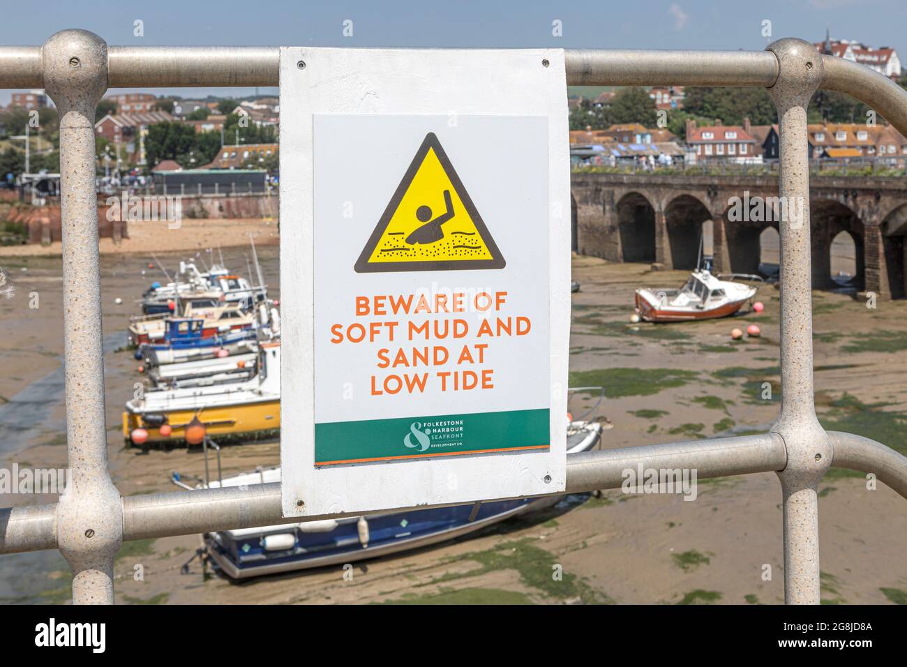 A sign saying beware of soft mud and sand on Folkestone Harbour, Kent ...