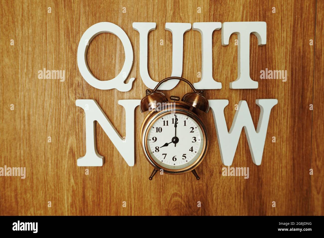 Quit Now alphabet letter with alarm clock on wooden background Stock ...