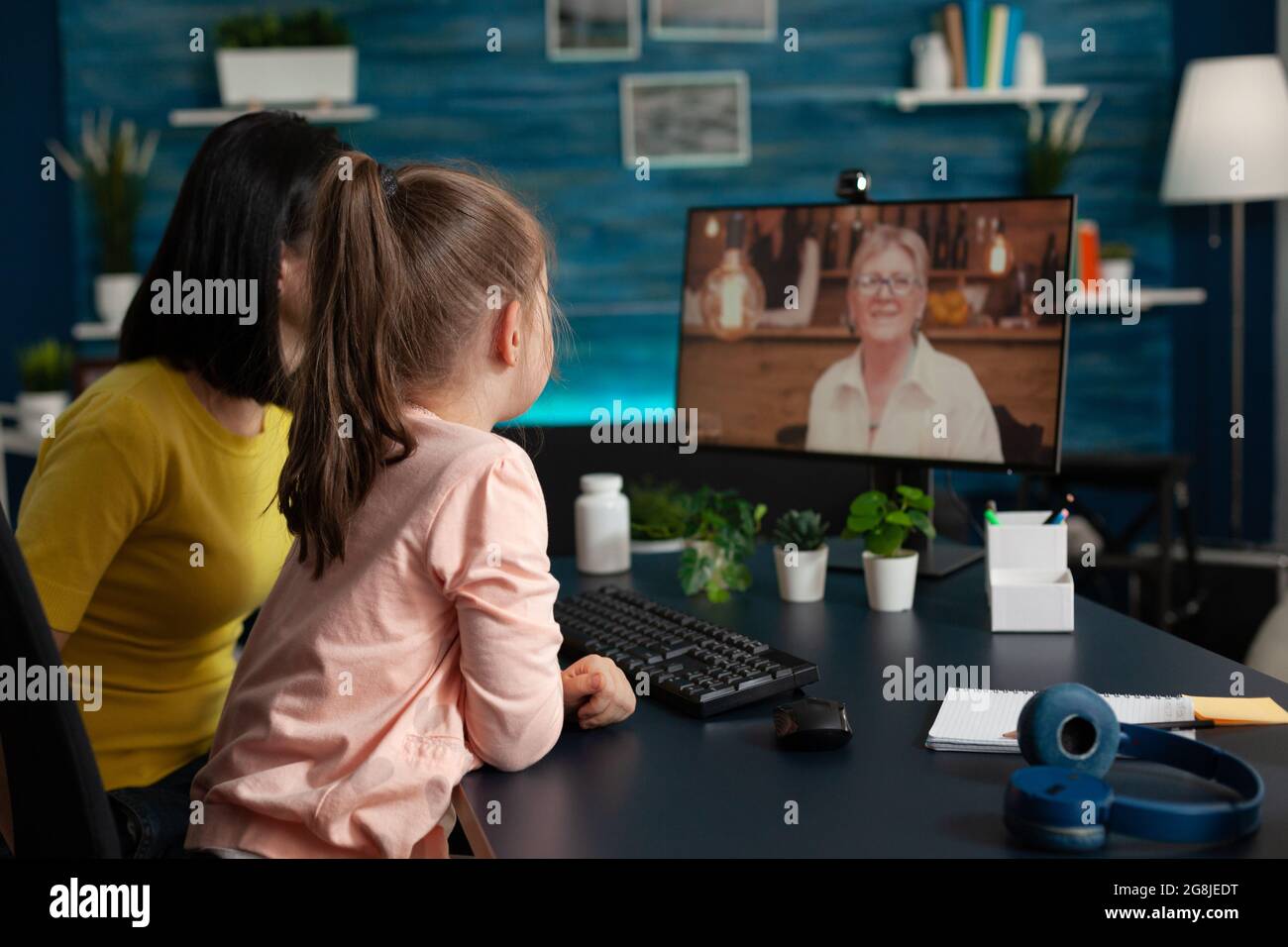 Parent and little kid meeting with grandma on video call virtual ...