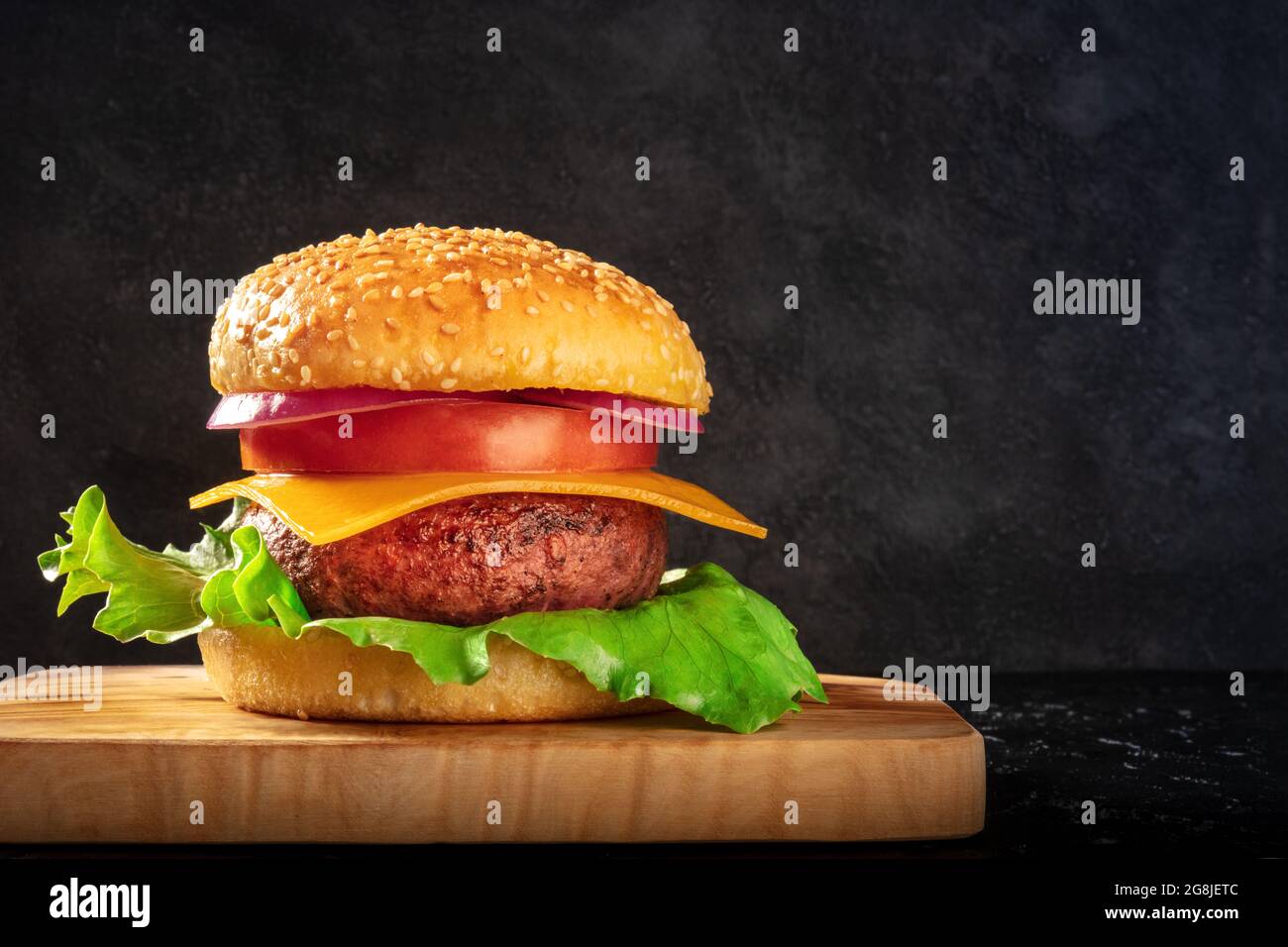 Burger, side view with copy space. Hamburger with a fat beef patty ...
