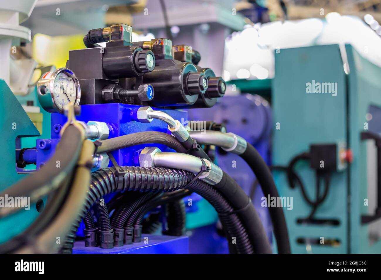 Part of automatic injection molding machine and plastic hoses at ...