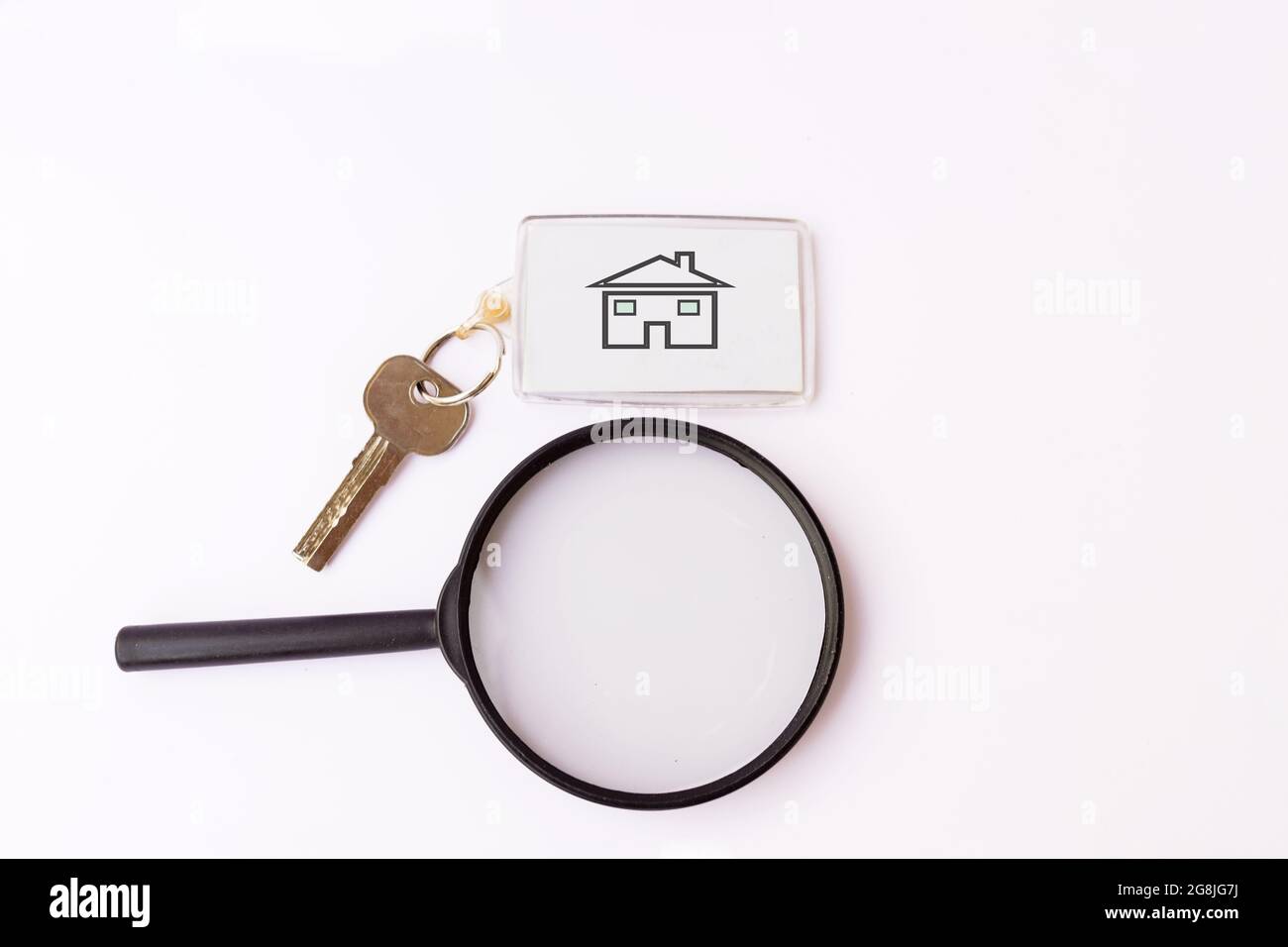 Top view of a magnifying glass and key with keychain isolated on white ...