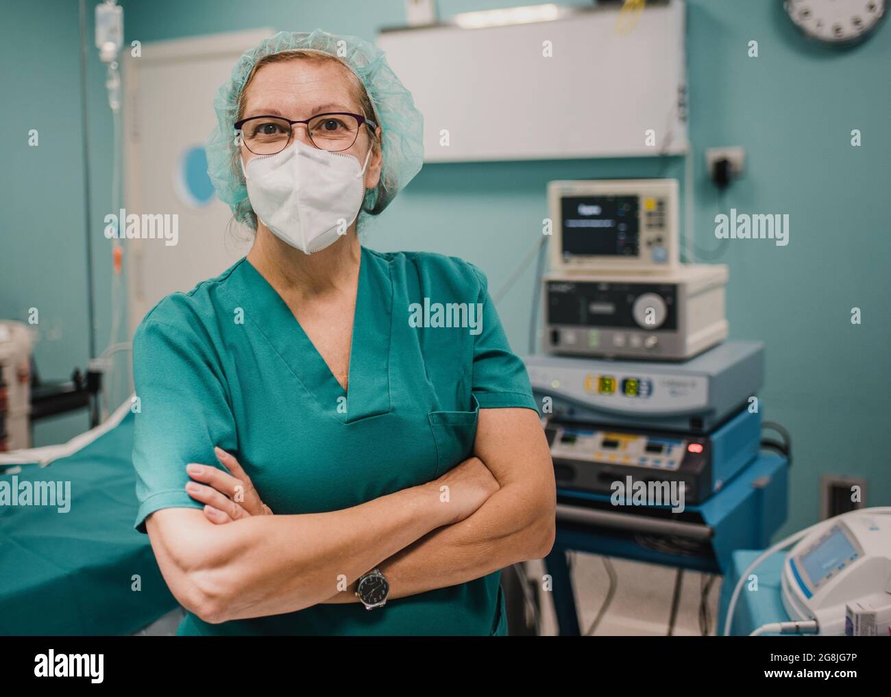 Portrait of female nurse looking at camera inside operating theater at ...