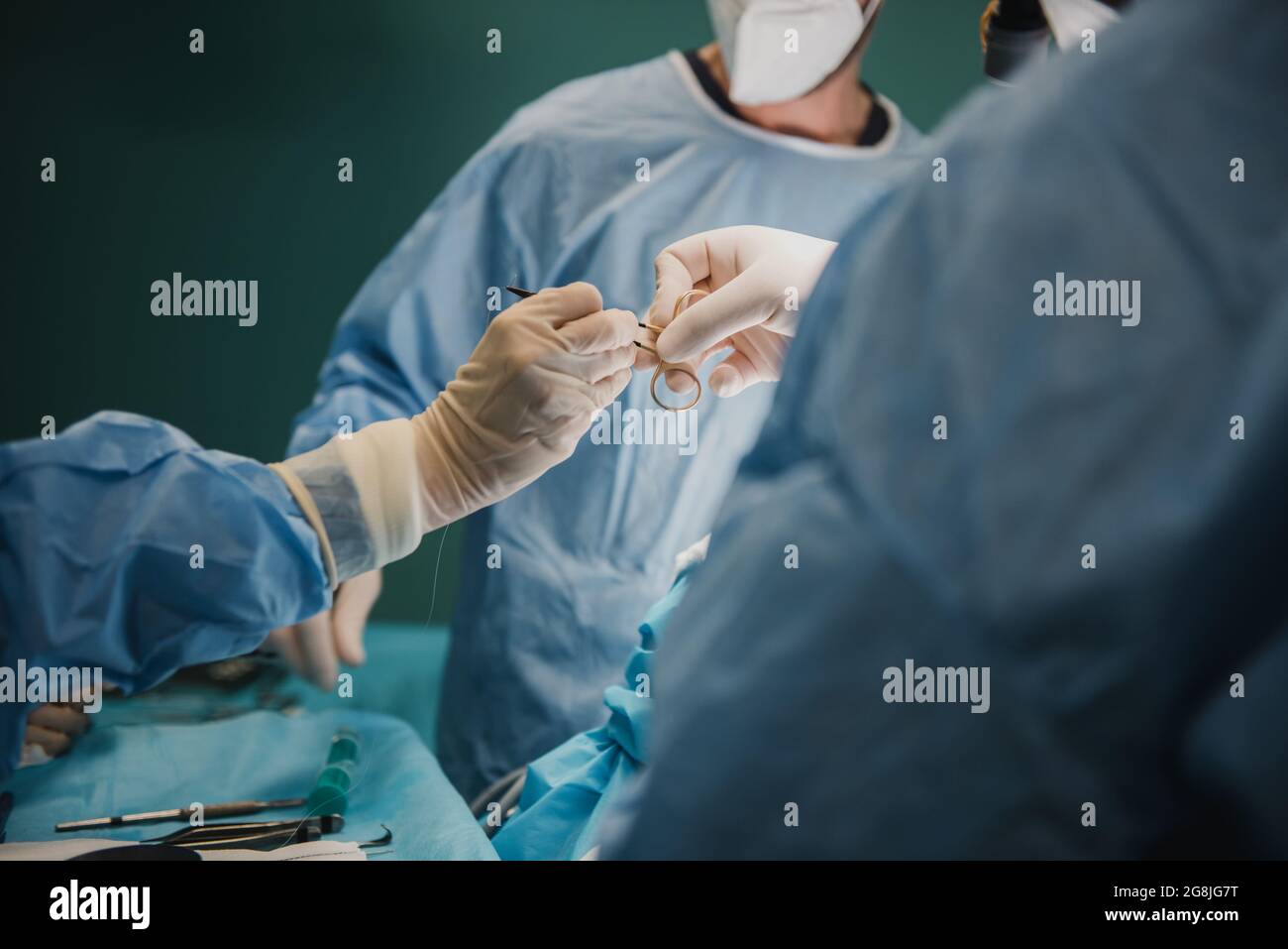 Medical surgeon team operating patient in surgical room at private ...