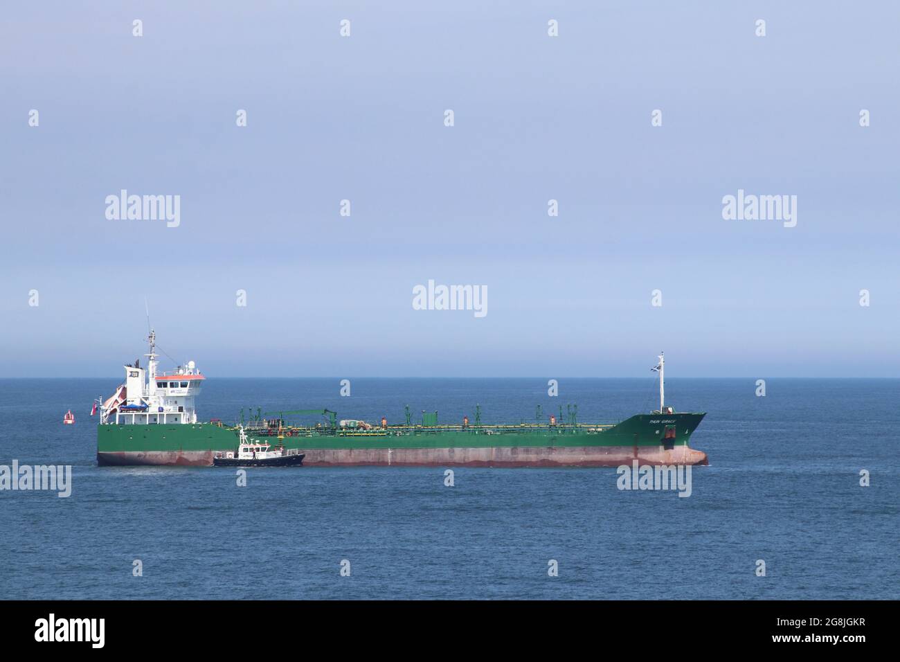 Cargo ship and pilot boat Stock Photo - Alamy
