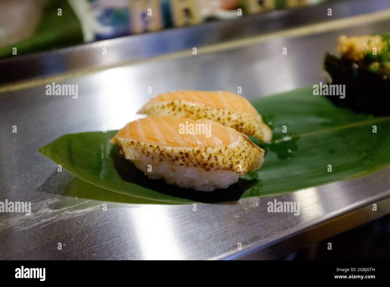 Salmon sashimi on a green leaf Stock Photo - Alamy