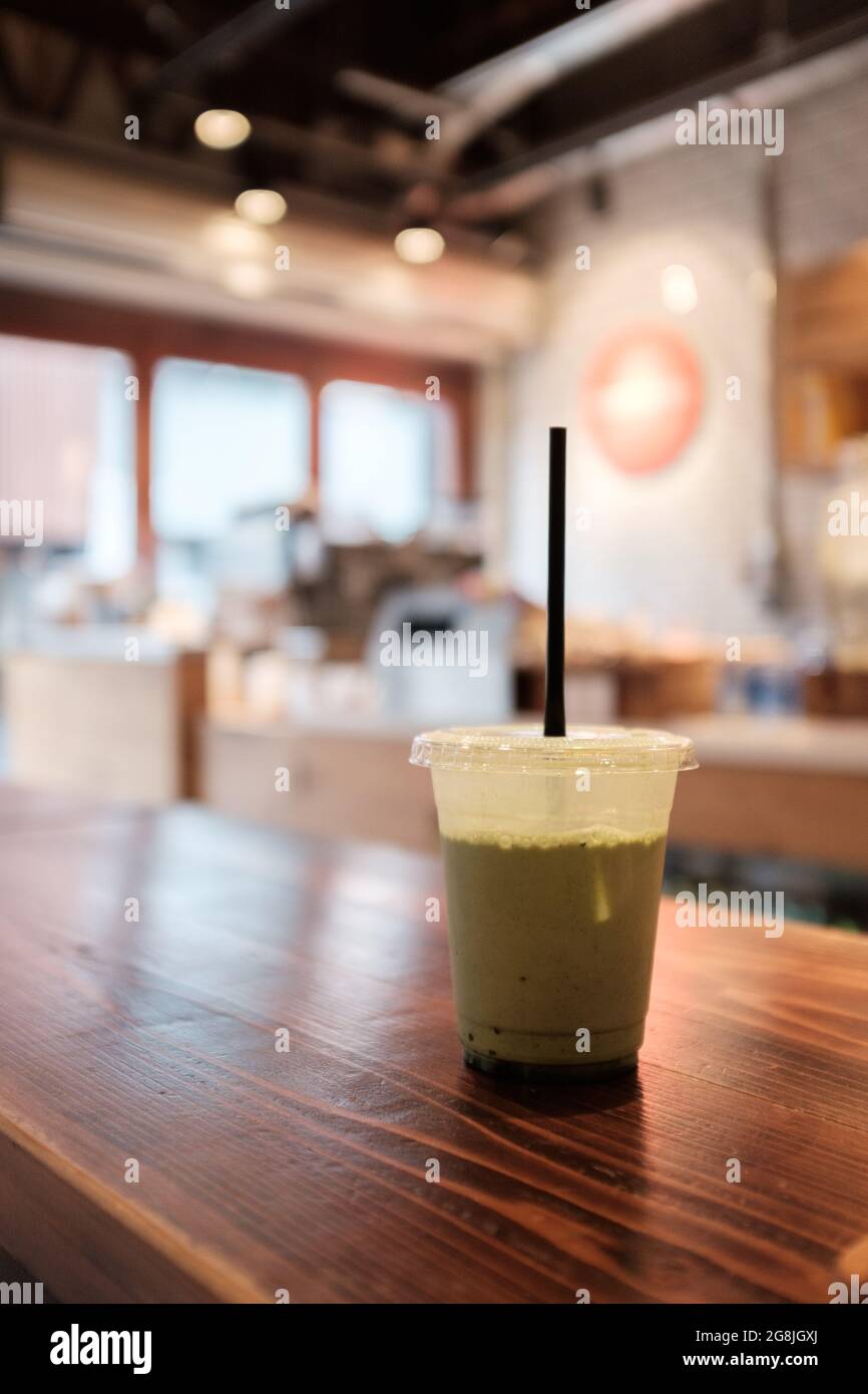 Plastic cup of cold coffee on the bar counter at the cafe Stock Photo ...