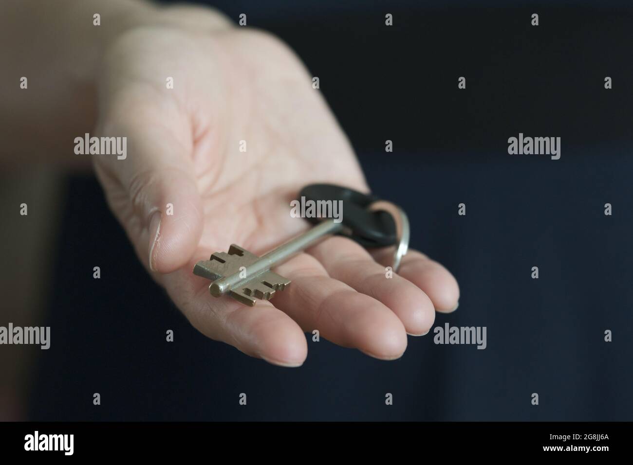 The hand holds the key from the door lock Stock Photo - Alamy