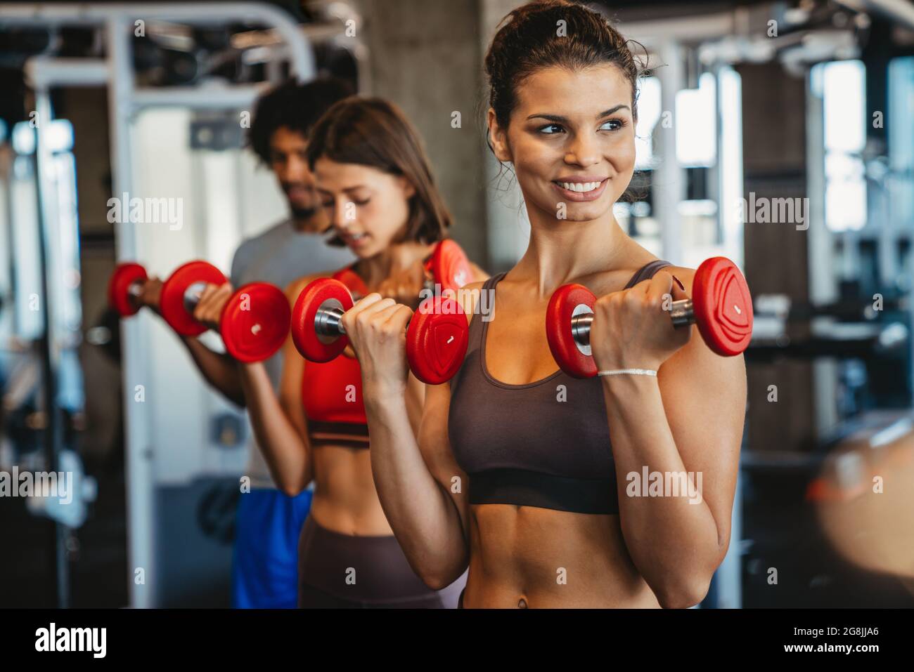 Beautiful fit people working out in gym together Stock Photo - Alamy