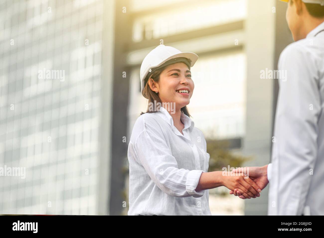 Hand Shake concept, Businesswoman shake hand and smile with Engineer ...