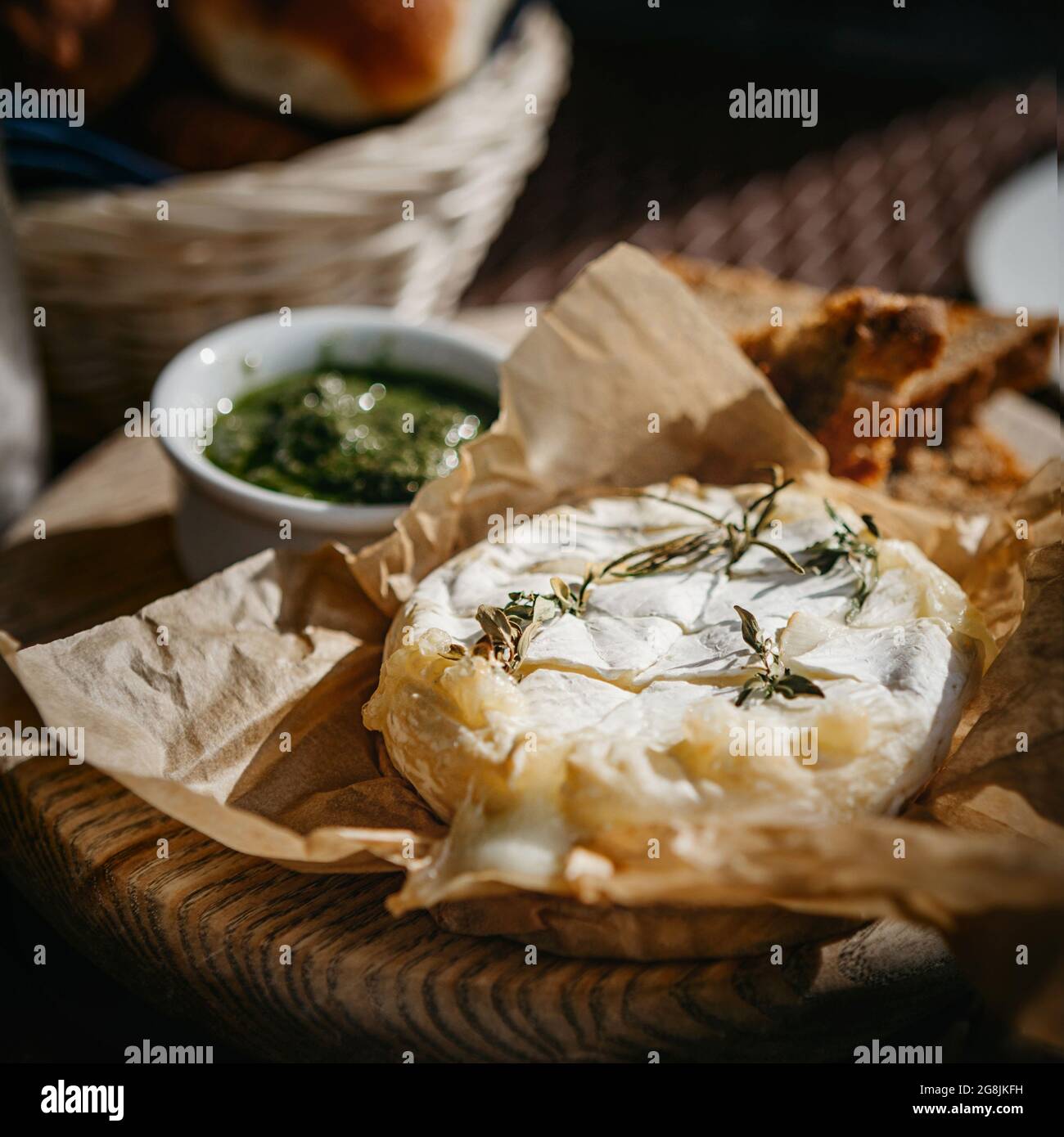 Oven baked camembert cheese with rosemary and pesto sauce Stock Photo ...